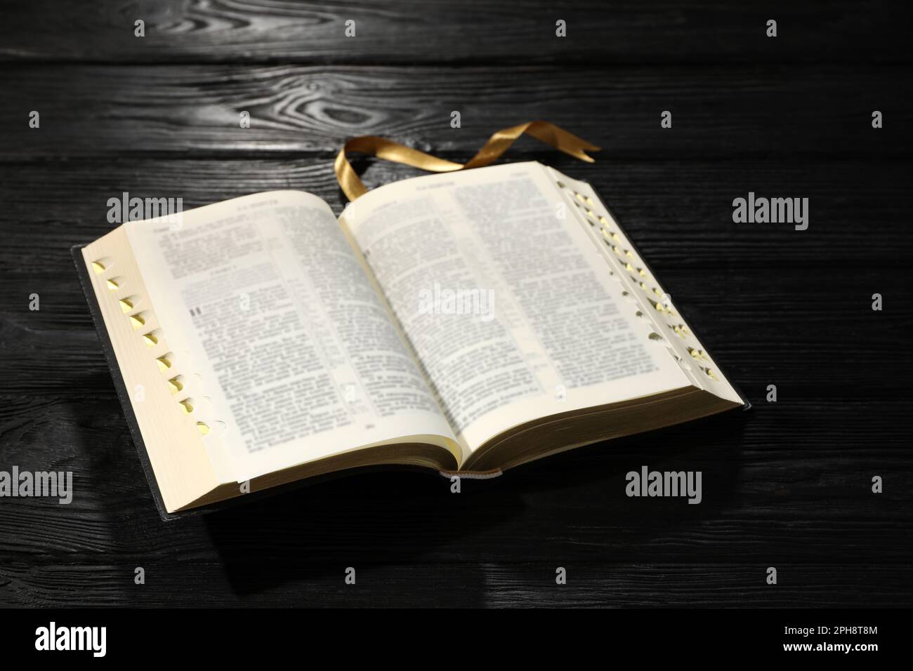 Open Bible on black wooden table. Christian religious book Stock Photo ...