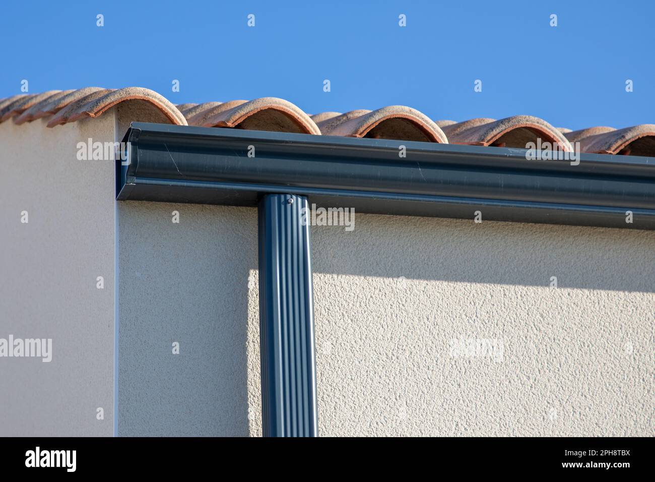 grey aluminium gutter system corner house facade Stock Photo - Alamy