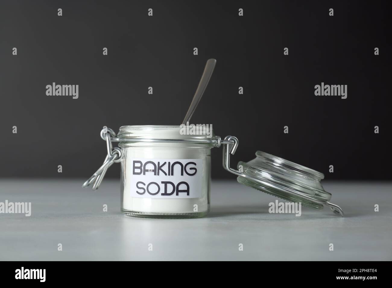 Open jar with baking soda on grey table Stock Photo - Alamy
