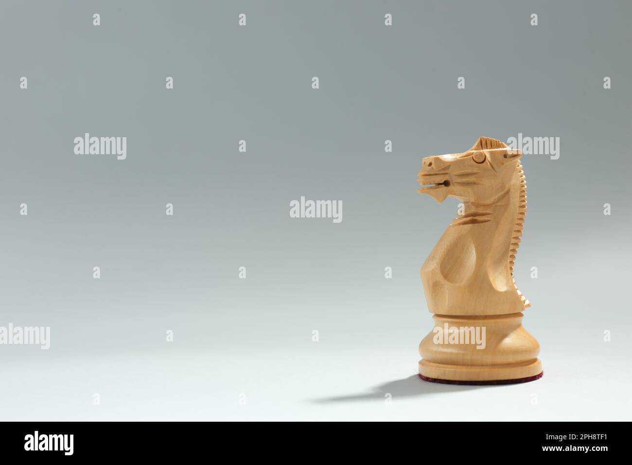 Wooden knight on light background, space for text. Chess piece Stock ...