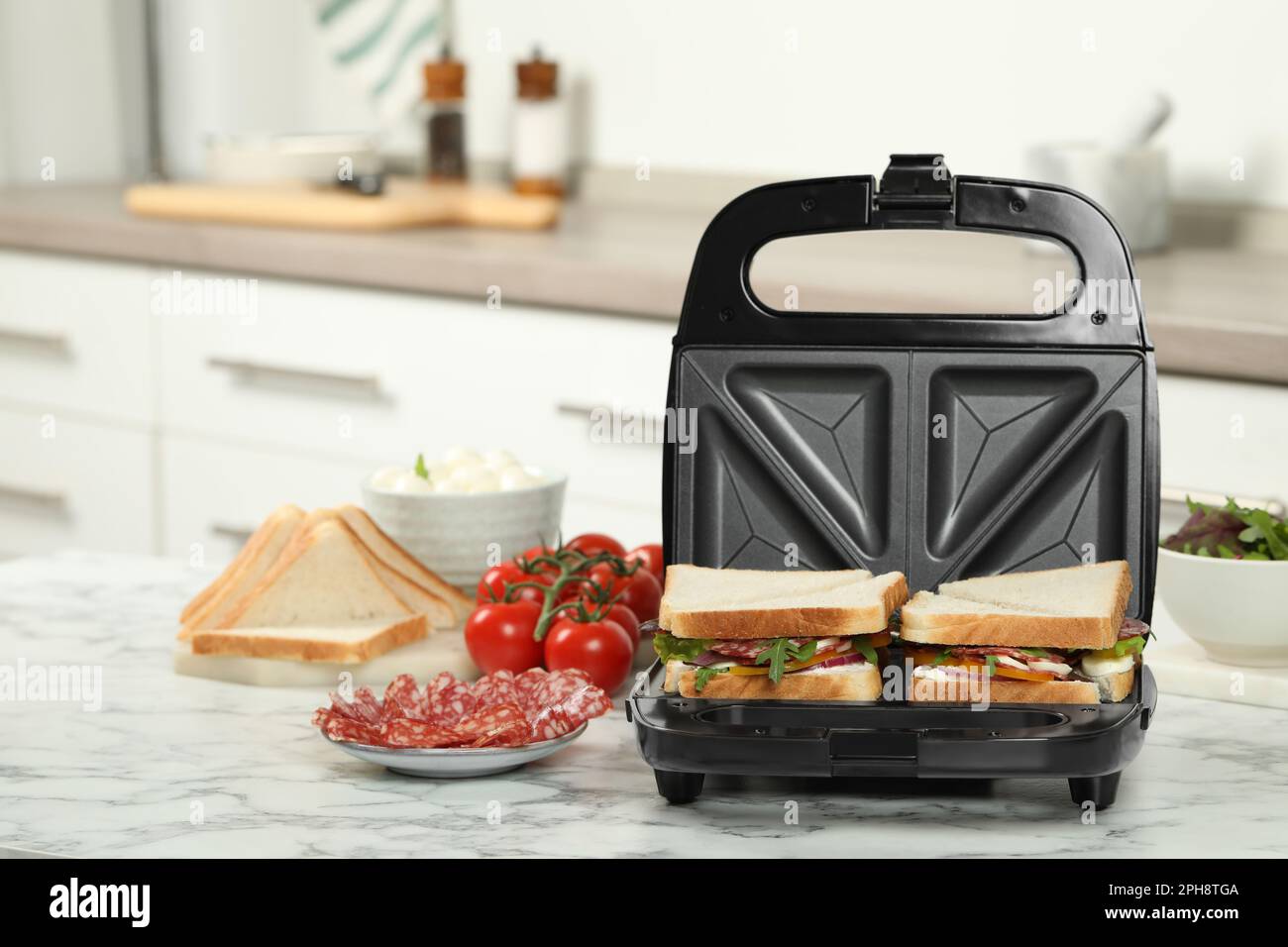 Modern grill maker with sandwiches and different products on white ...