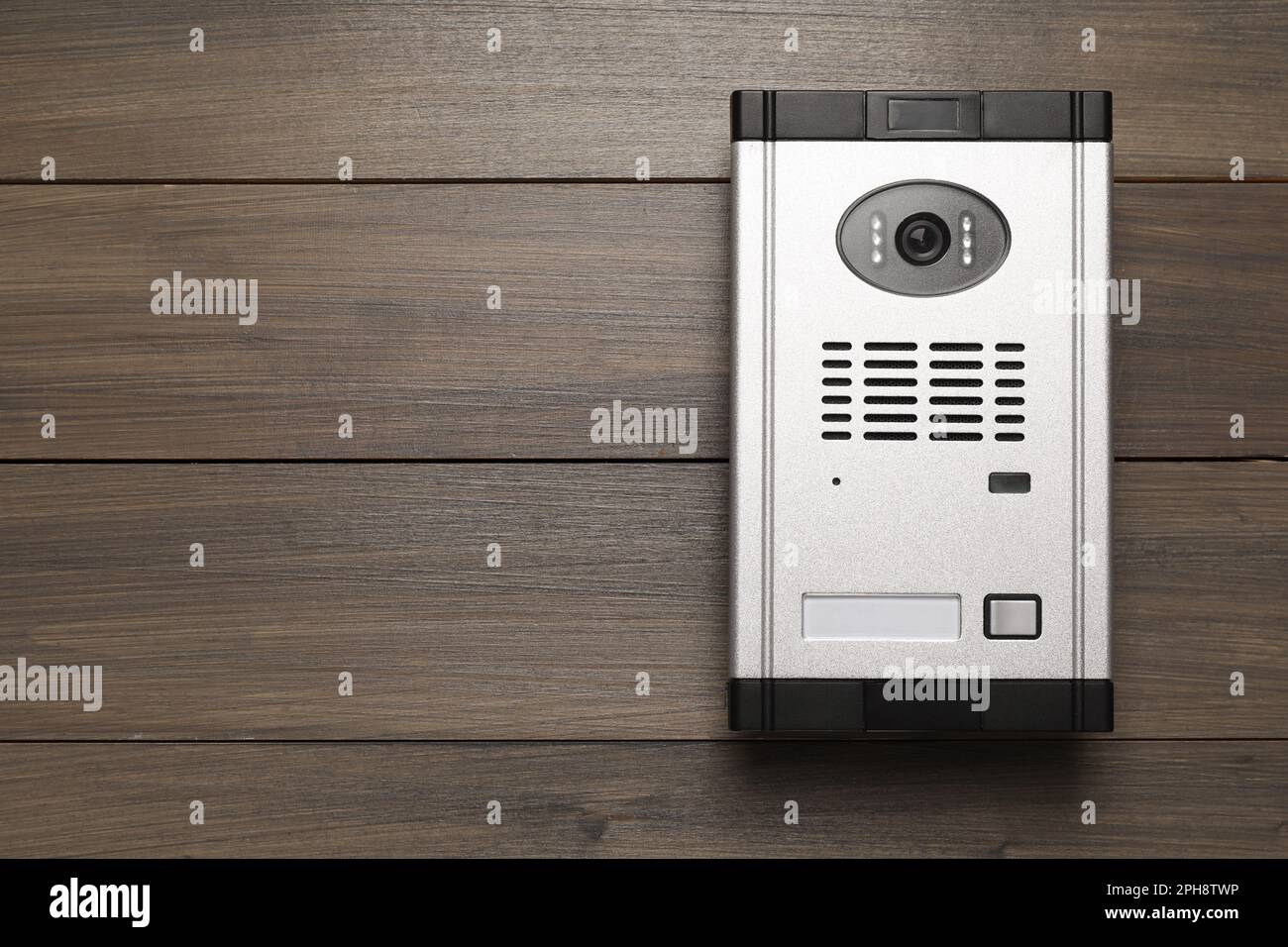 Modern intercom system with camera on wooden background, top view ...