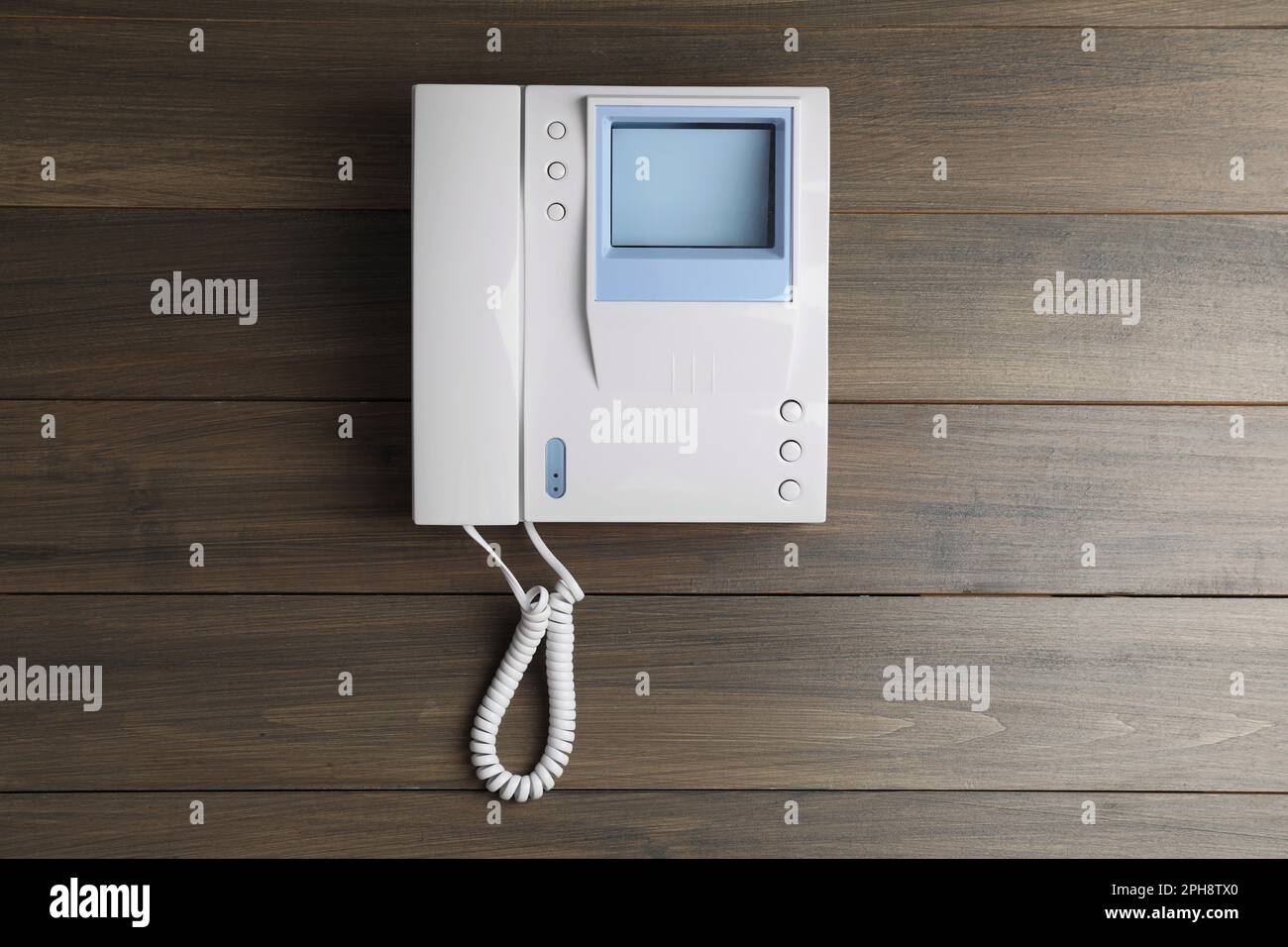 Modern intercom system with handset on wooden background, top view ...