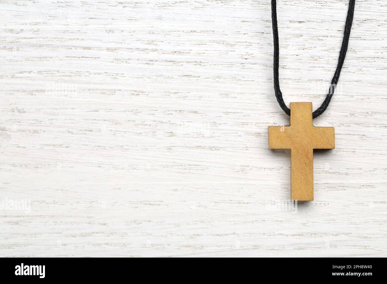 Wooden Christian cross on white table, top view. Space for text Stock ...