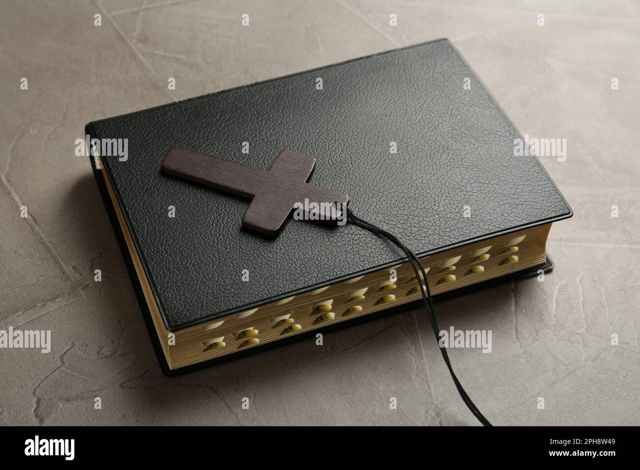 Wooden Christian cross and Bible on grey table Stock Photo - Alamy