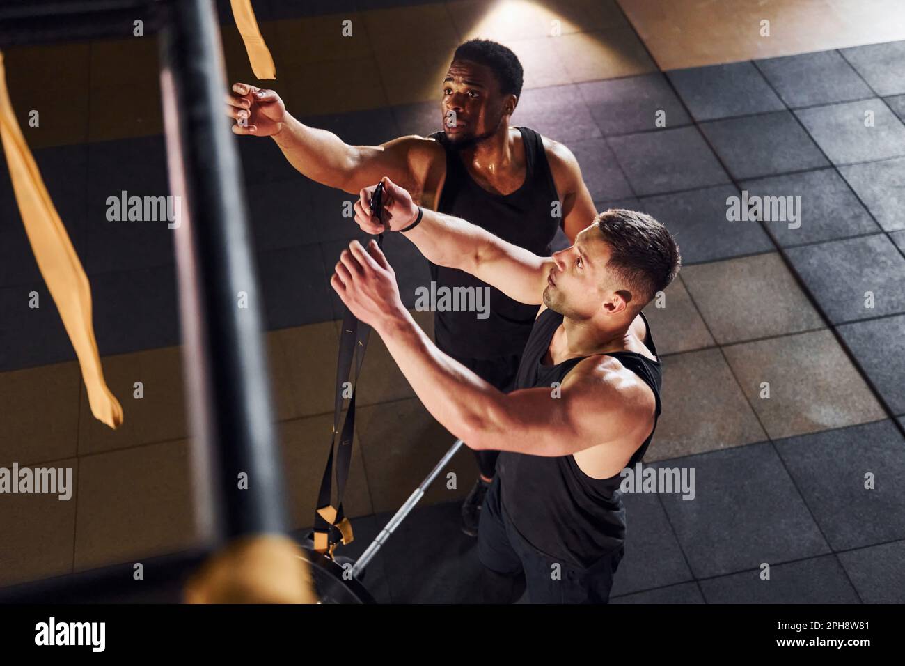 Personal trainer is on job. African american man with white guy have ...