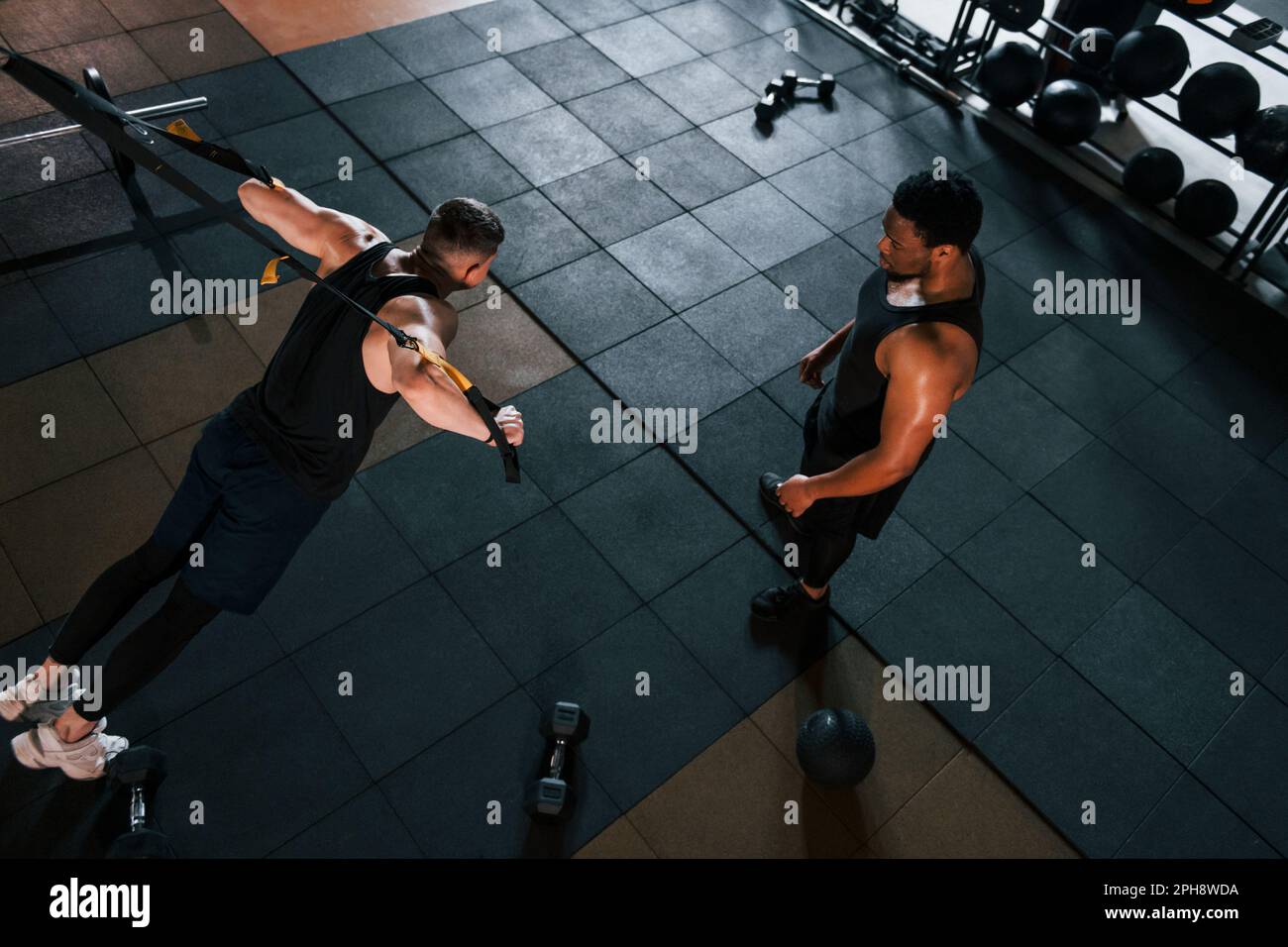 Personal trainer is on job. African american man with white guy have ...