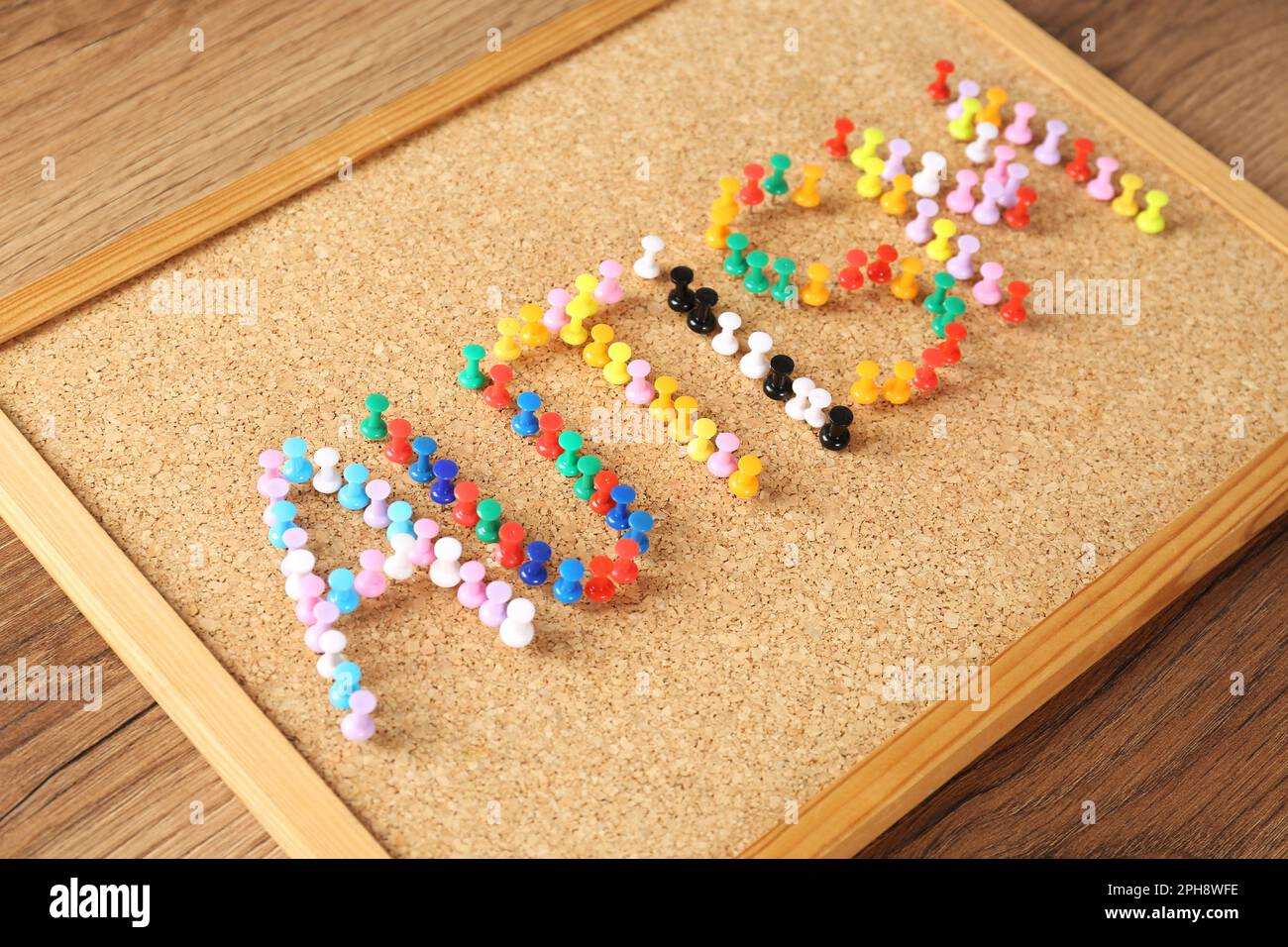 Cork board with word Autism made of colorful pins on wooden table ...
