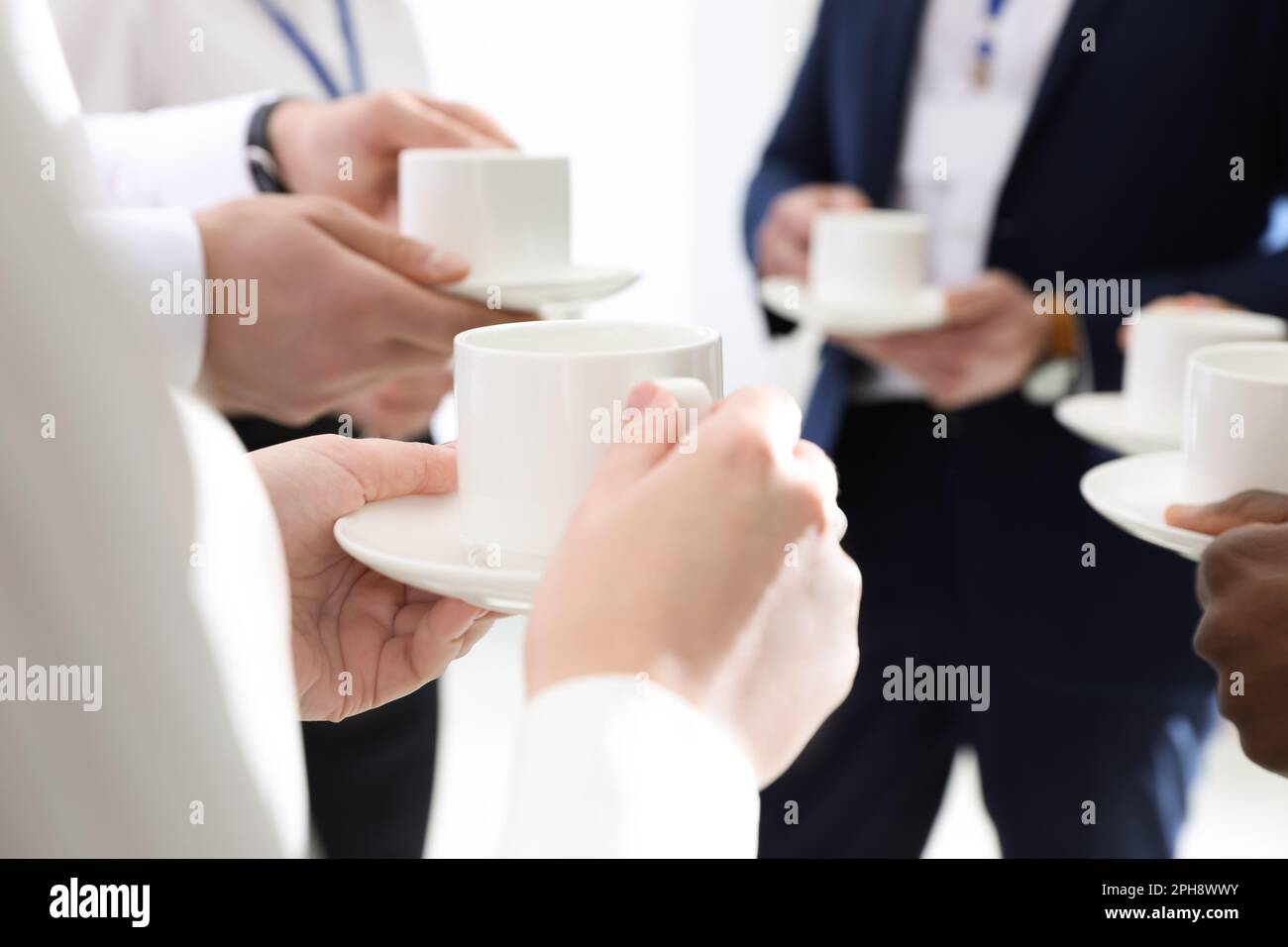 Group of people during coffee break, closeup Stock Photo - Alamy