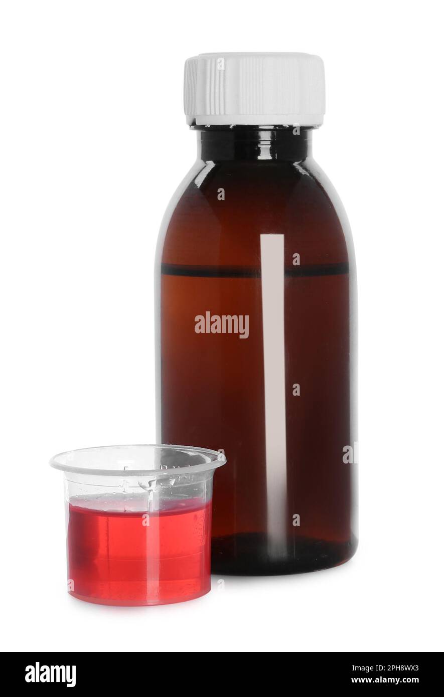 Bottle of cough syrup and measuring cup on white background Stock Photo ...