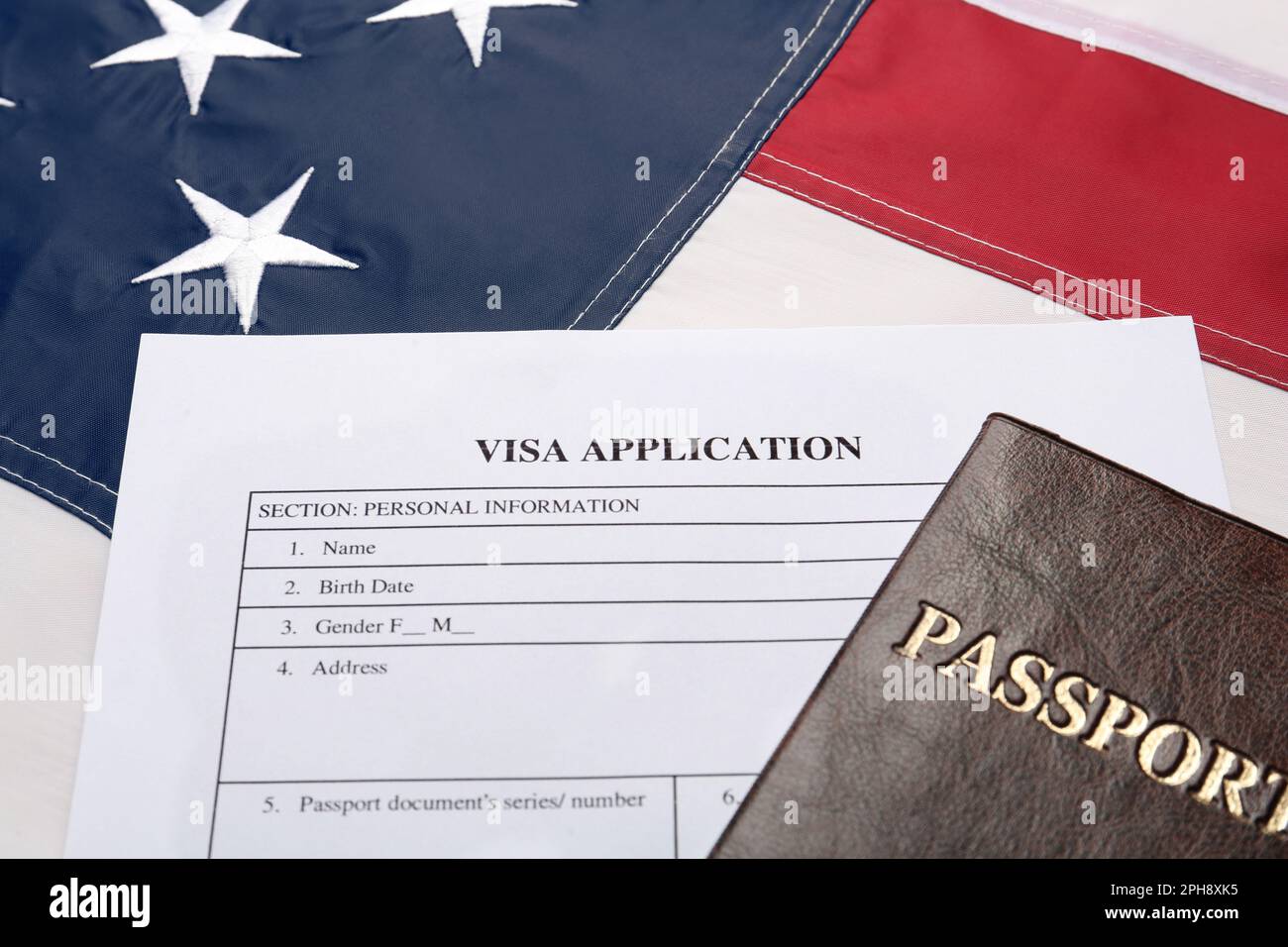 Visa application form and passport on American flag, closeup Stock ...