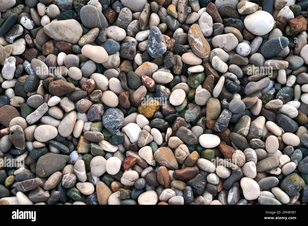 Smooth round wet pebbles texture background. Pebble sea beach close-up ...