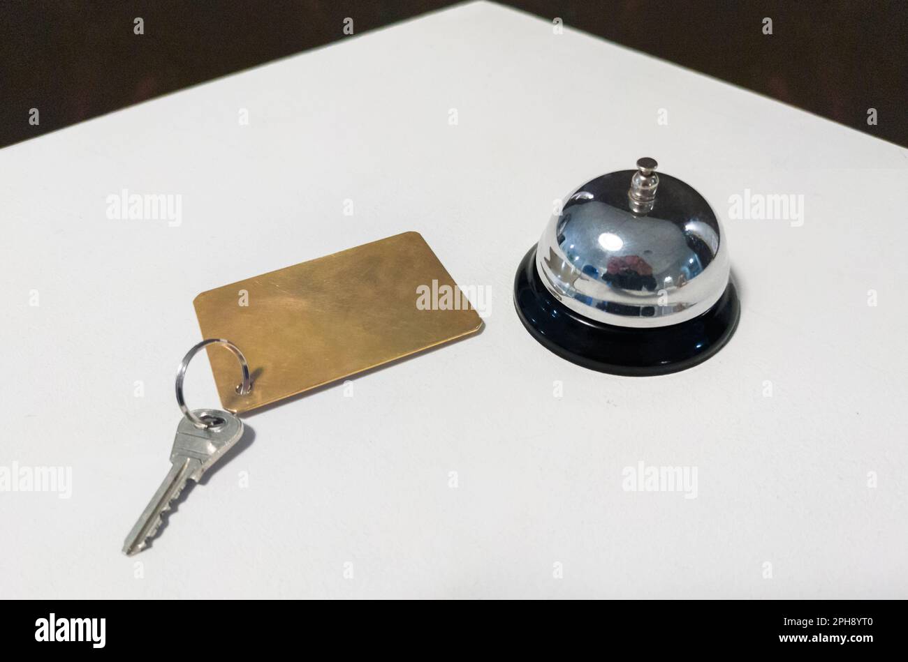 Service bell and keys over hotel reception desk. White surface Stock ...