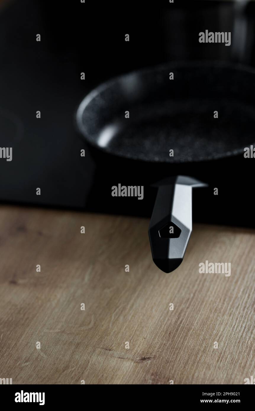 close up new kitchen frying pan is on induction cooker Stock Photo - Alamy