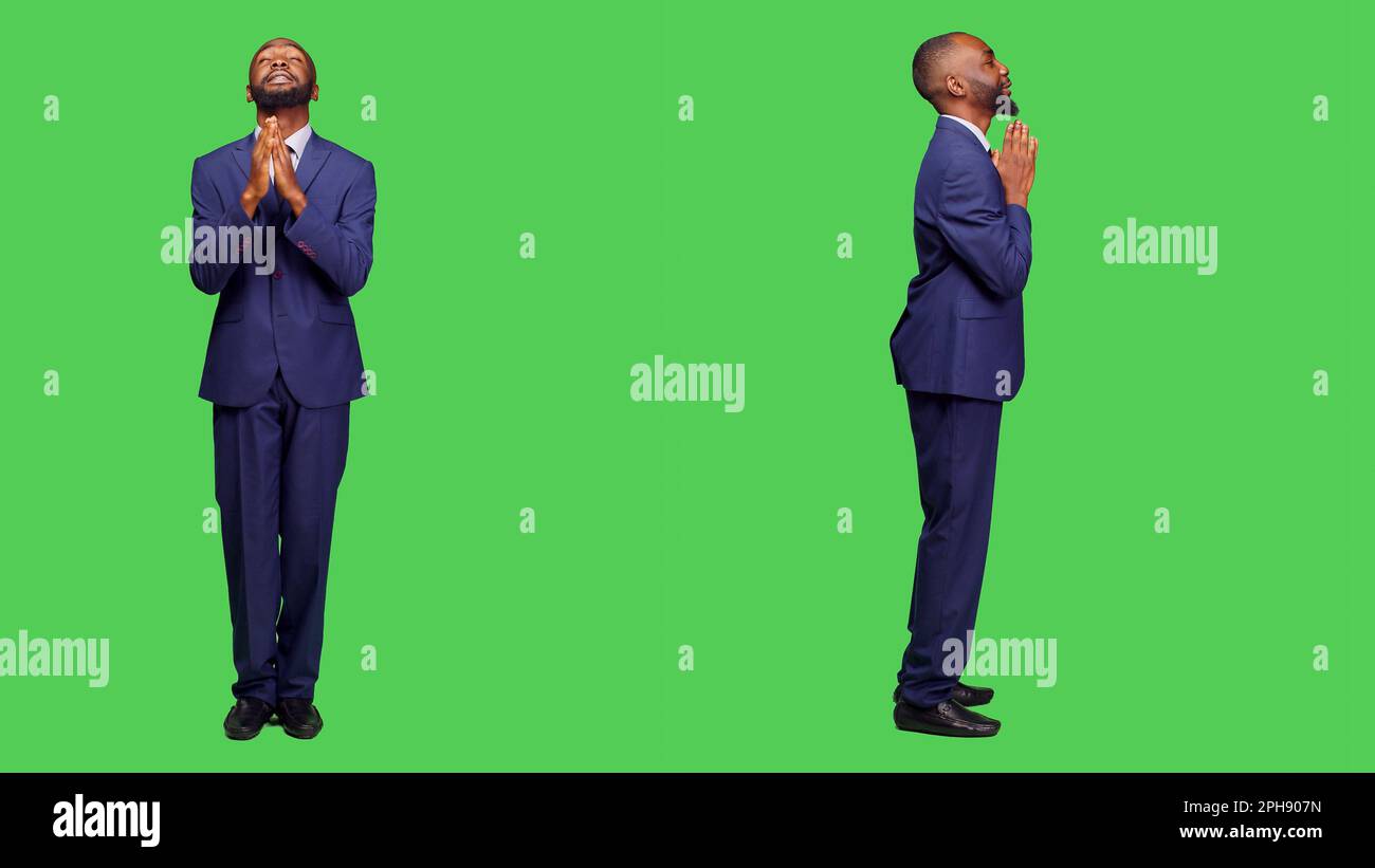 Startup entrepreneur praying to god for good luck in studio, wearing ...