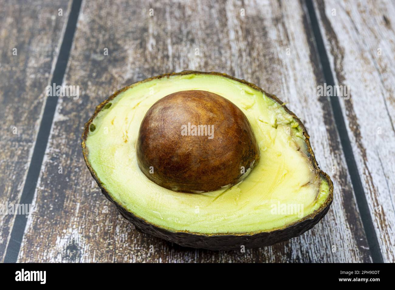 Fresh avocado cut in half Stock Photo - Alamy