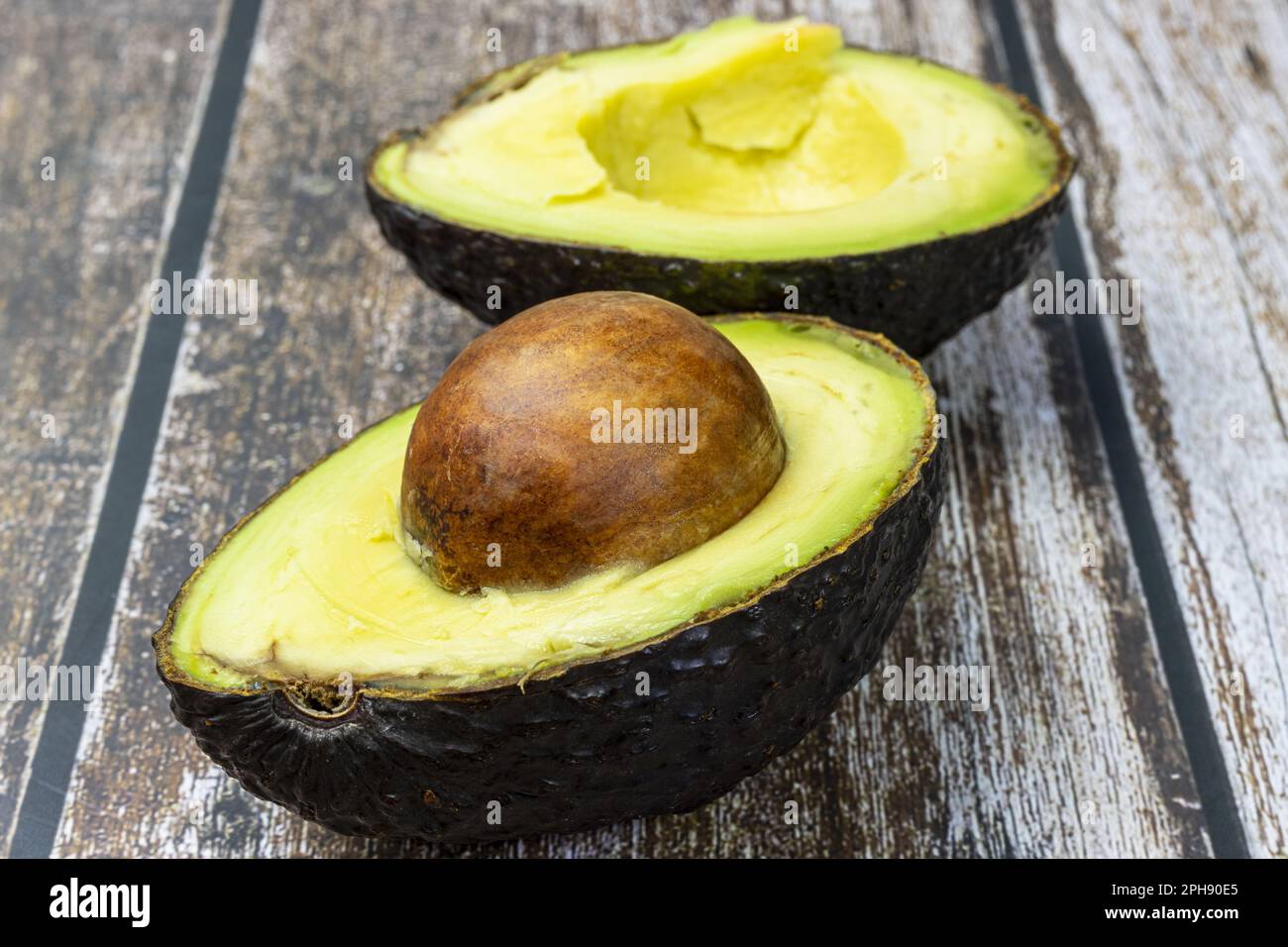 Fresh avocado cut in half Stock Photo - Alamy