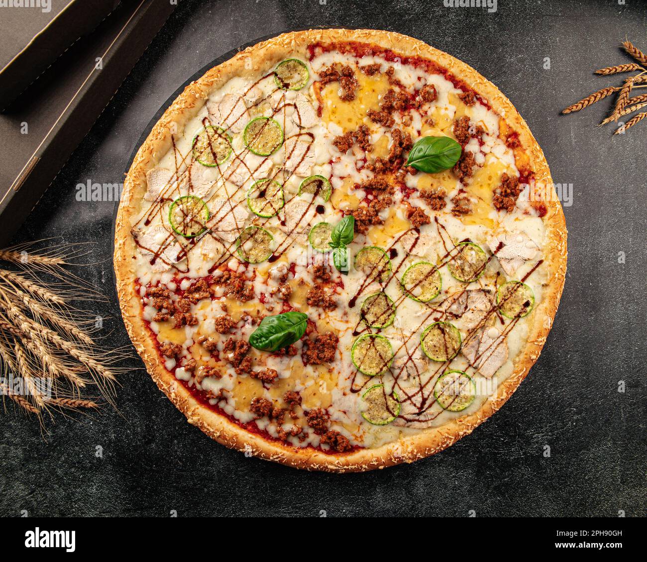Big assorted pizza with variety of toppings Stock Photo - Alamy