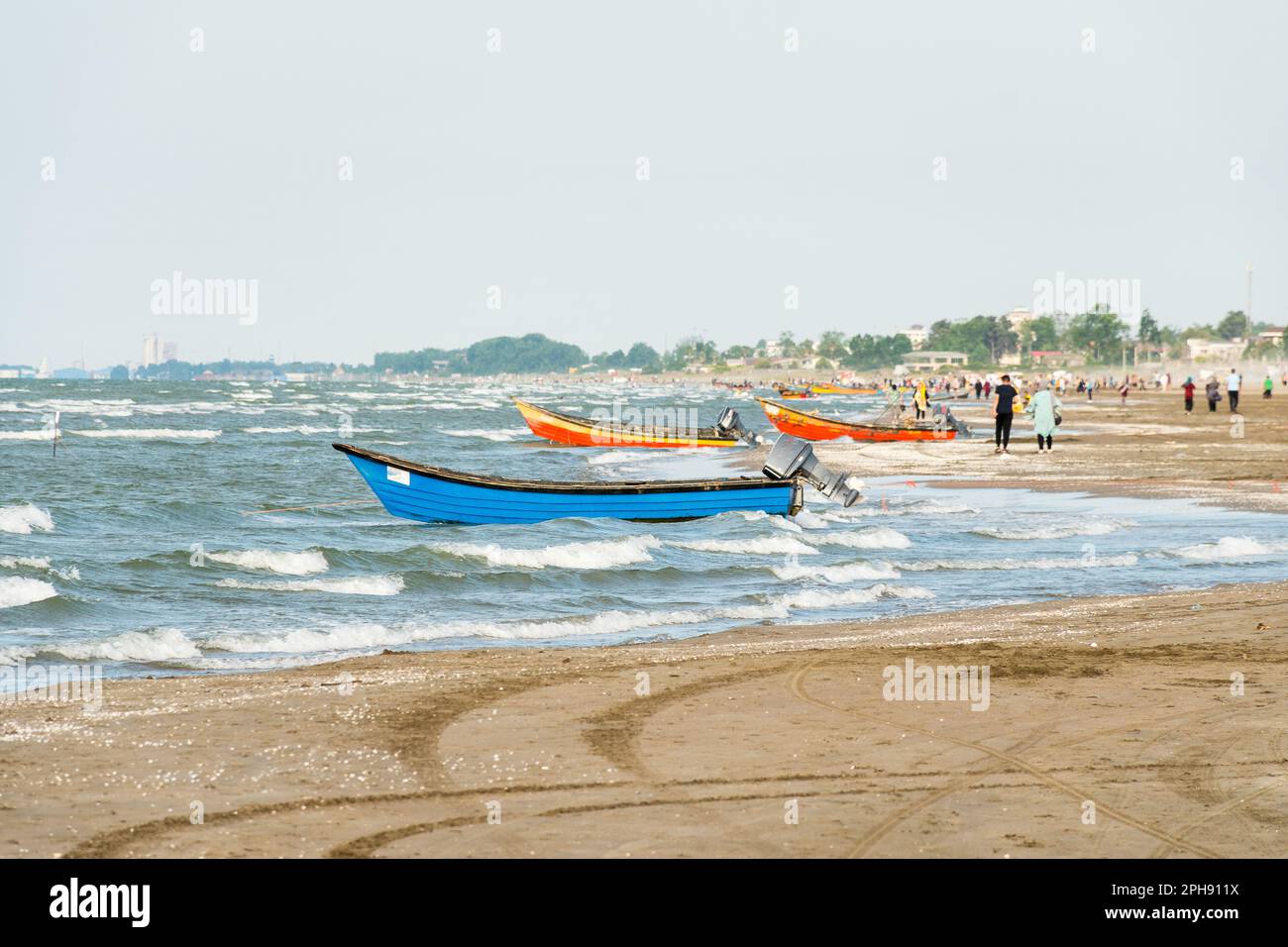 Traditional iranian colorful wooden motor boats on caspian sea shore in ...
