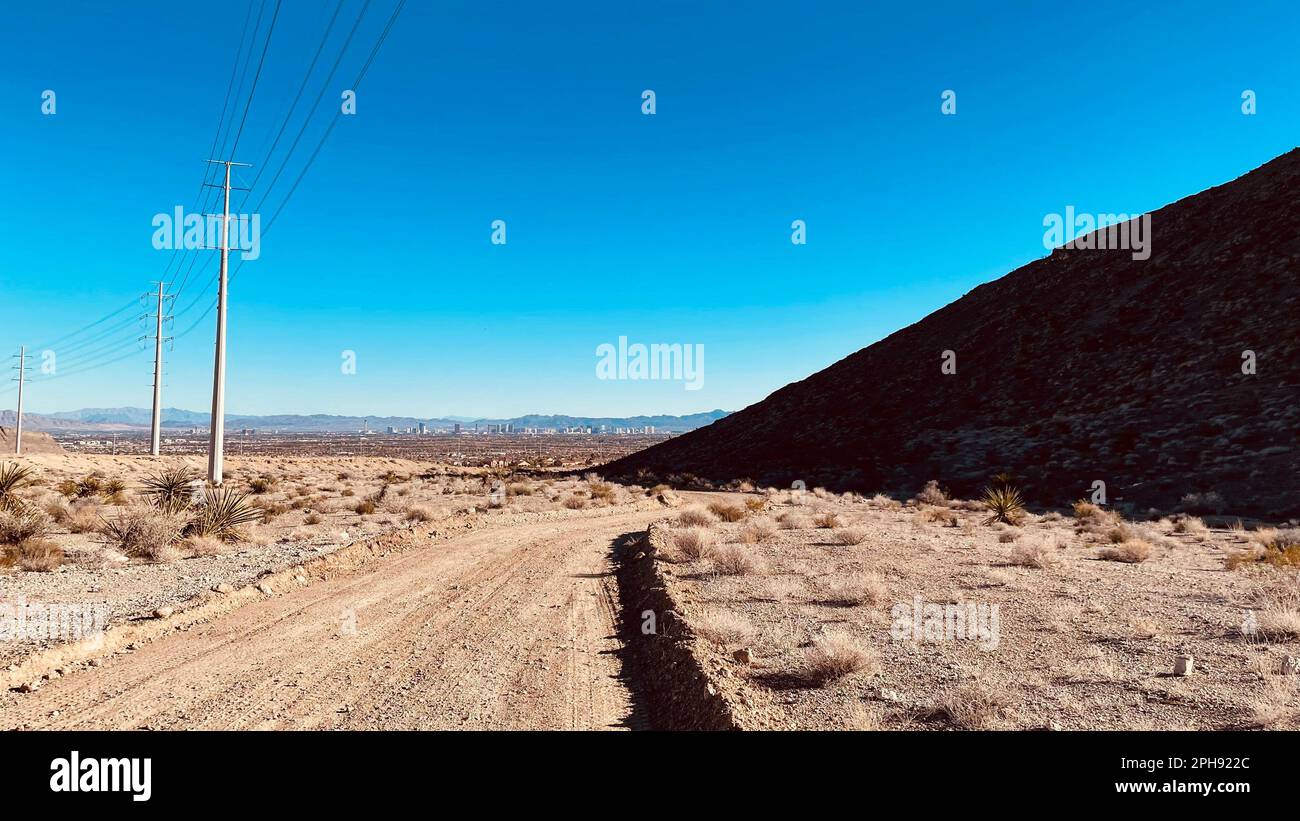A scenic desert landscape featuring an empty road stretching into the ...