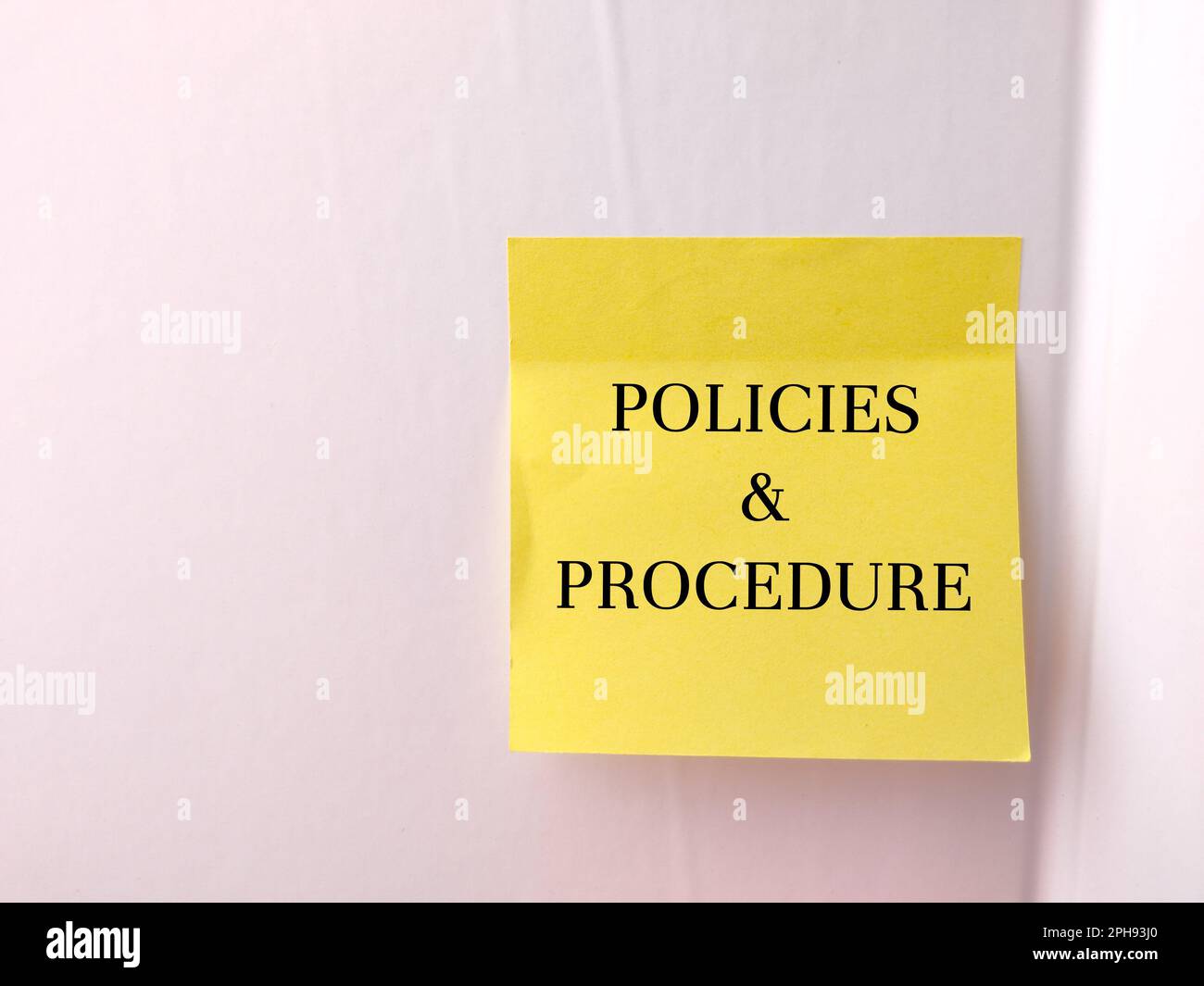 Colored sticky notepaper with the word POLICIES AND PROCEDURE on white ...