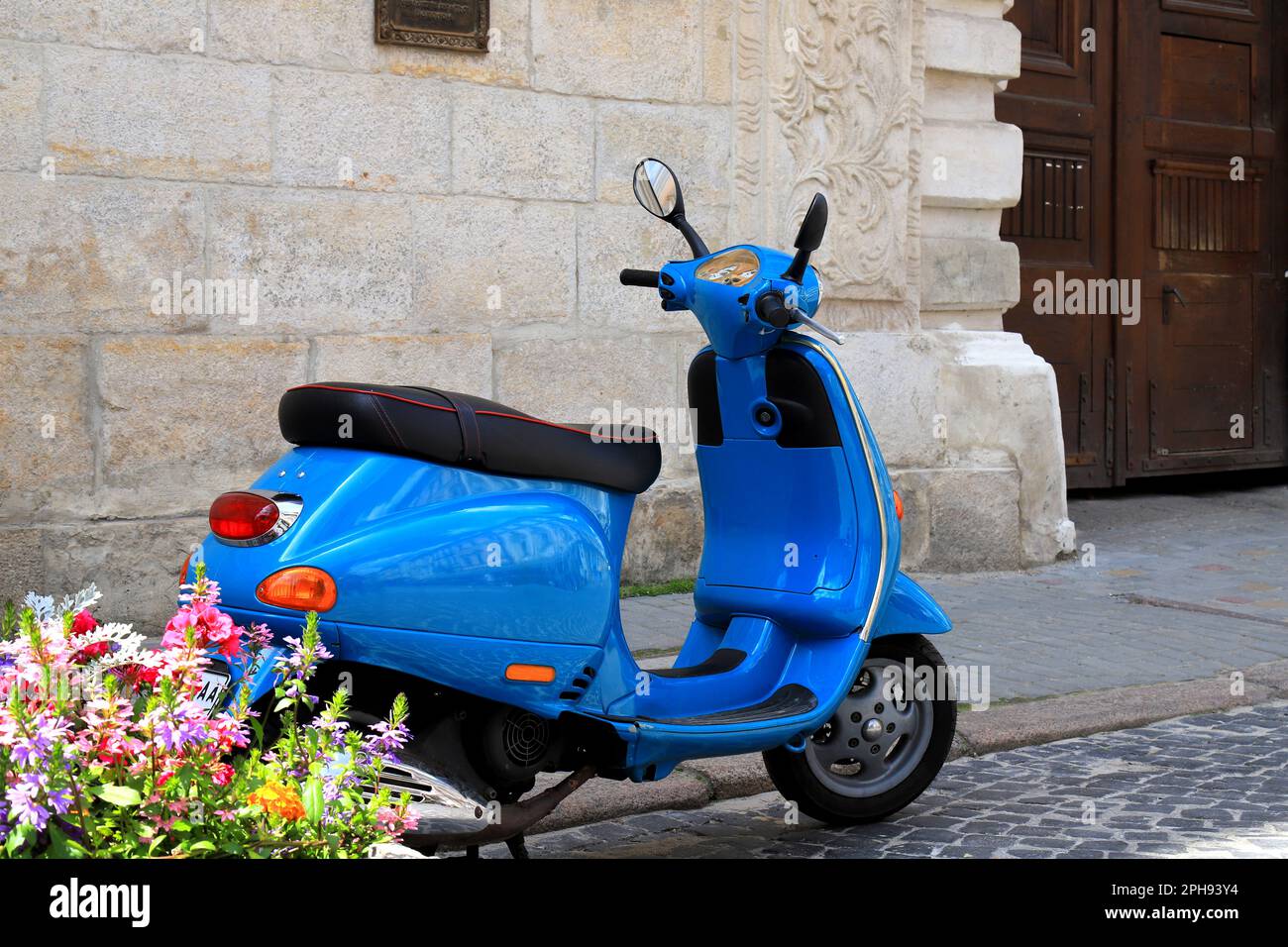 Retro scooter in old city of Lviv. Retro film. Old blue moped on city ...