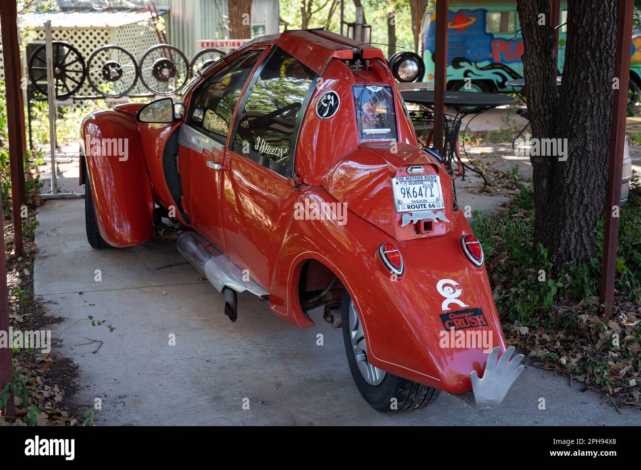 An image of a bright red vintage automobile with a three wheels Stock ...