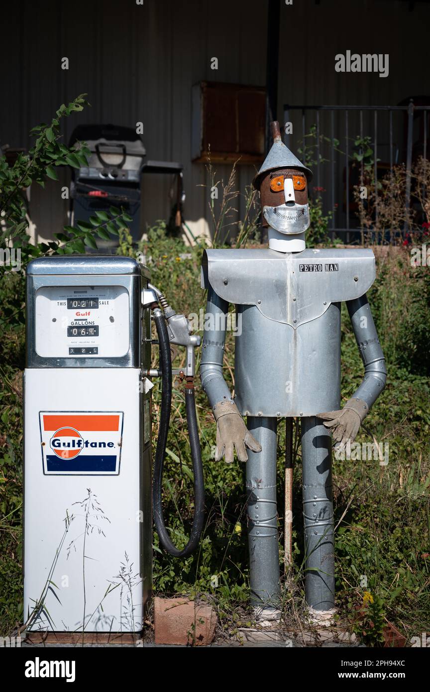 A vintage metal mannequin wearing a formal suit standing beside a ...