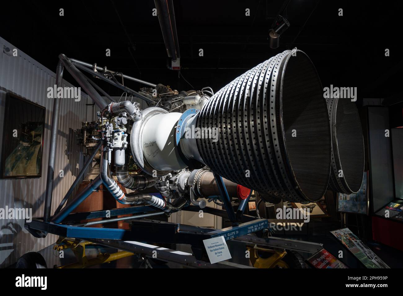 A sleek, silver jet engine resting on a light-colored work stand inside ...