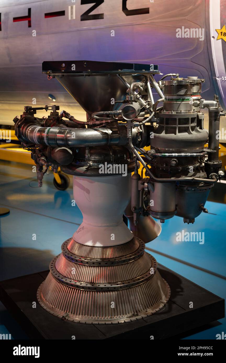 A vertical photograph of a jet airliner engine, with the sky in the ...