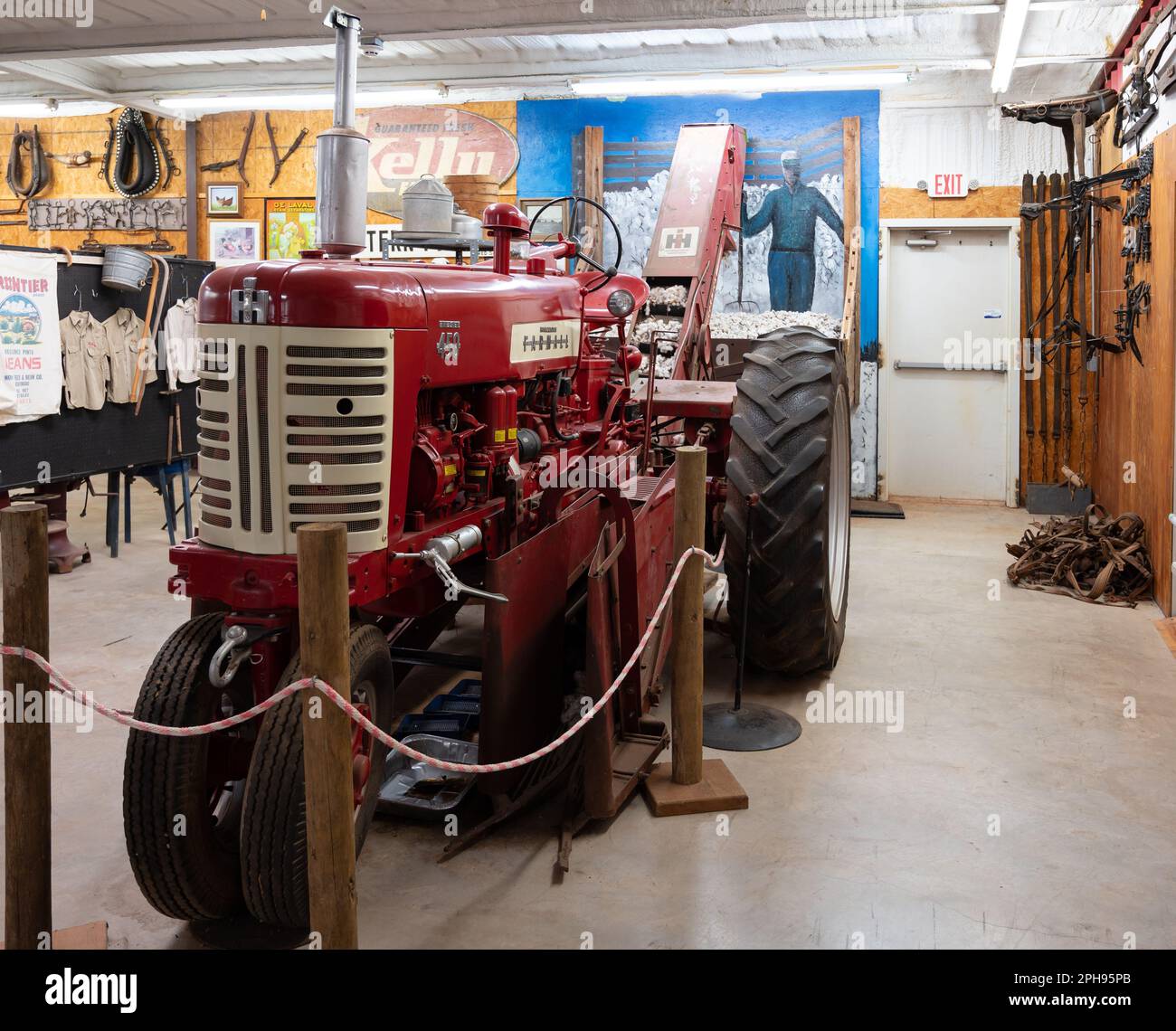 An antique farm tractor is on display in a museum exhibit room Stock ...