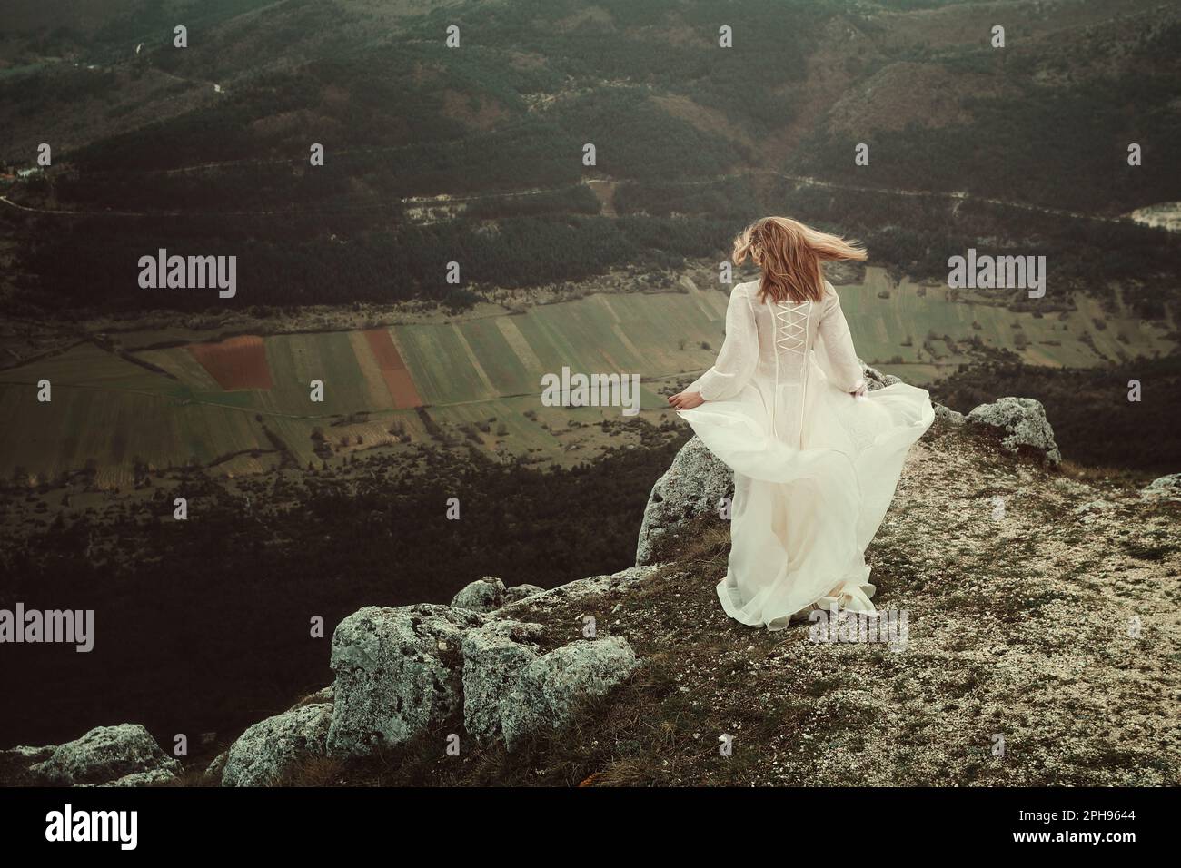 Lone woman on a desolate mountain top Stock Photo - Alamy