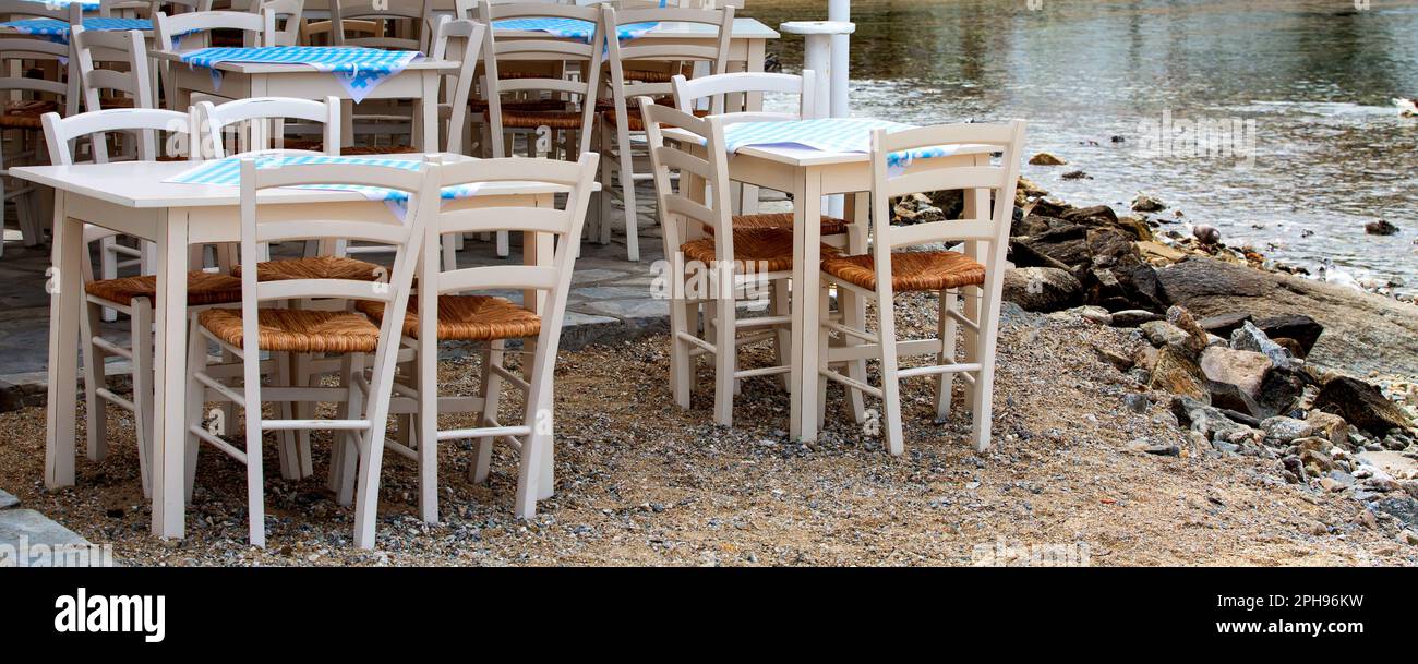 Row of White and blue greek tables and chairs in outdoor restaurant ...