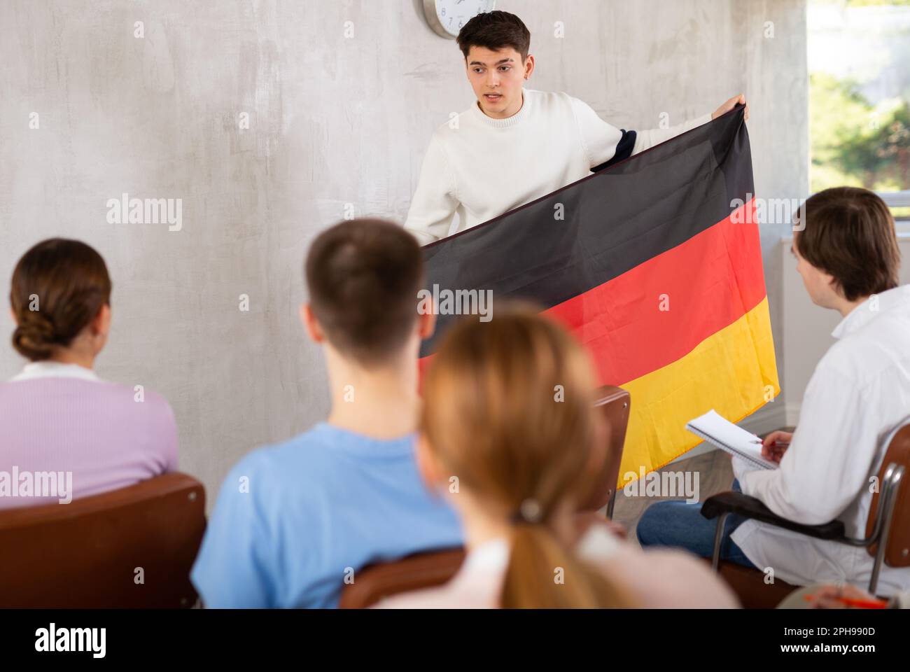 Young man tells his classmates the history of the state of Germany ...