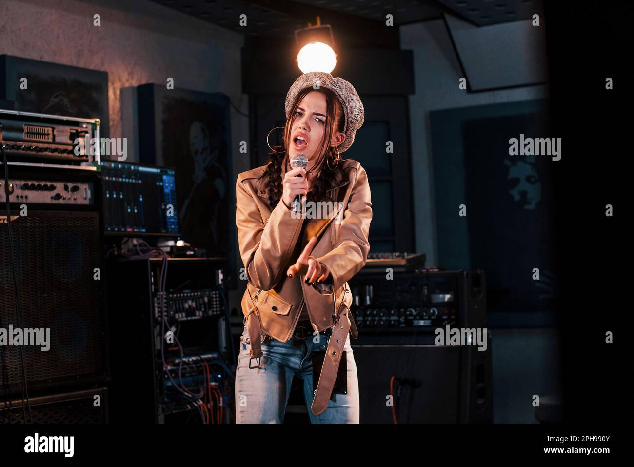Young beautiful female performer rehearsing in a recording studio Stock ...