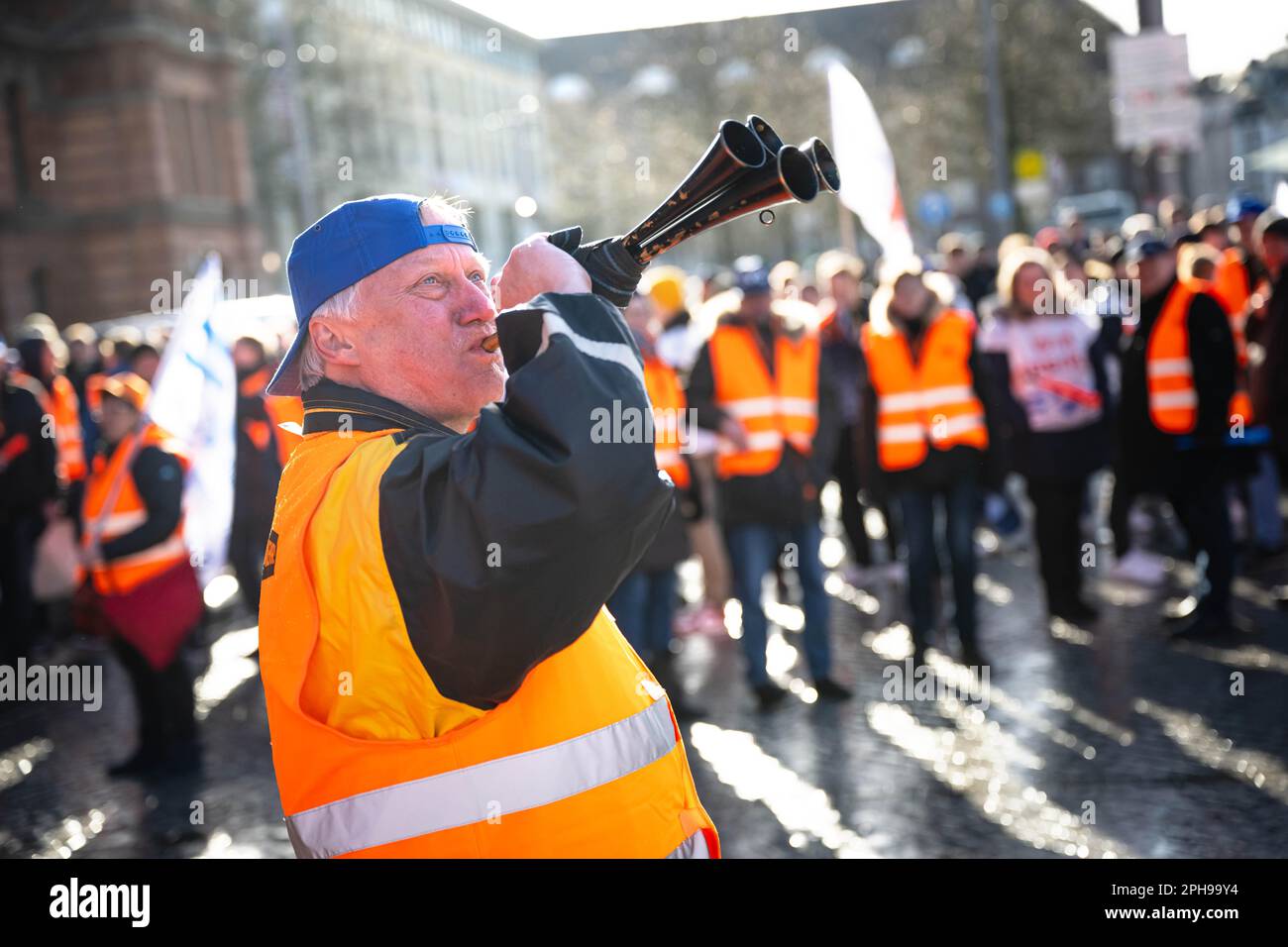 Bremen, Germany. 27th Mar, 2023. A demonstrator stands with a signal ...