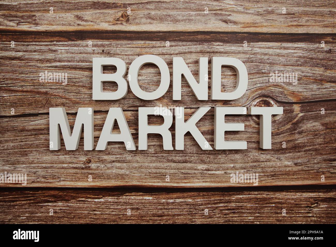 Bonds alphabet letters on wooden background Stock Photo - Alamy