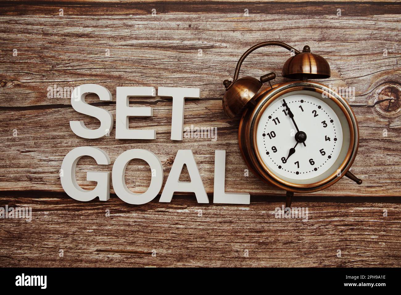 Set Goal alphabet letter and alarm clock on wooden background Stock ...