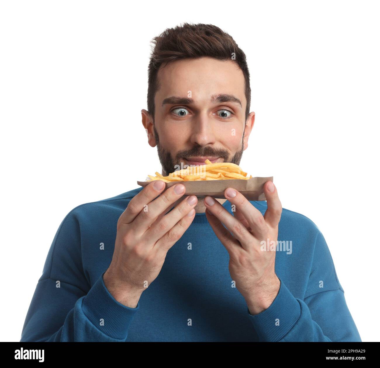 Hungry man with French fries on white background Stock Photo - Alamy