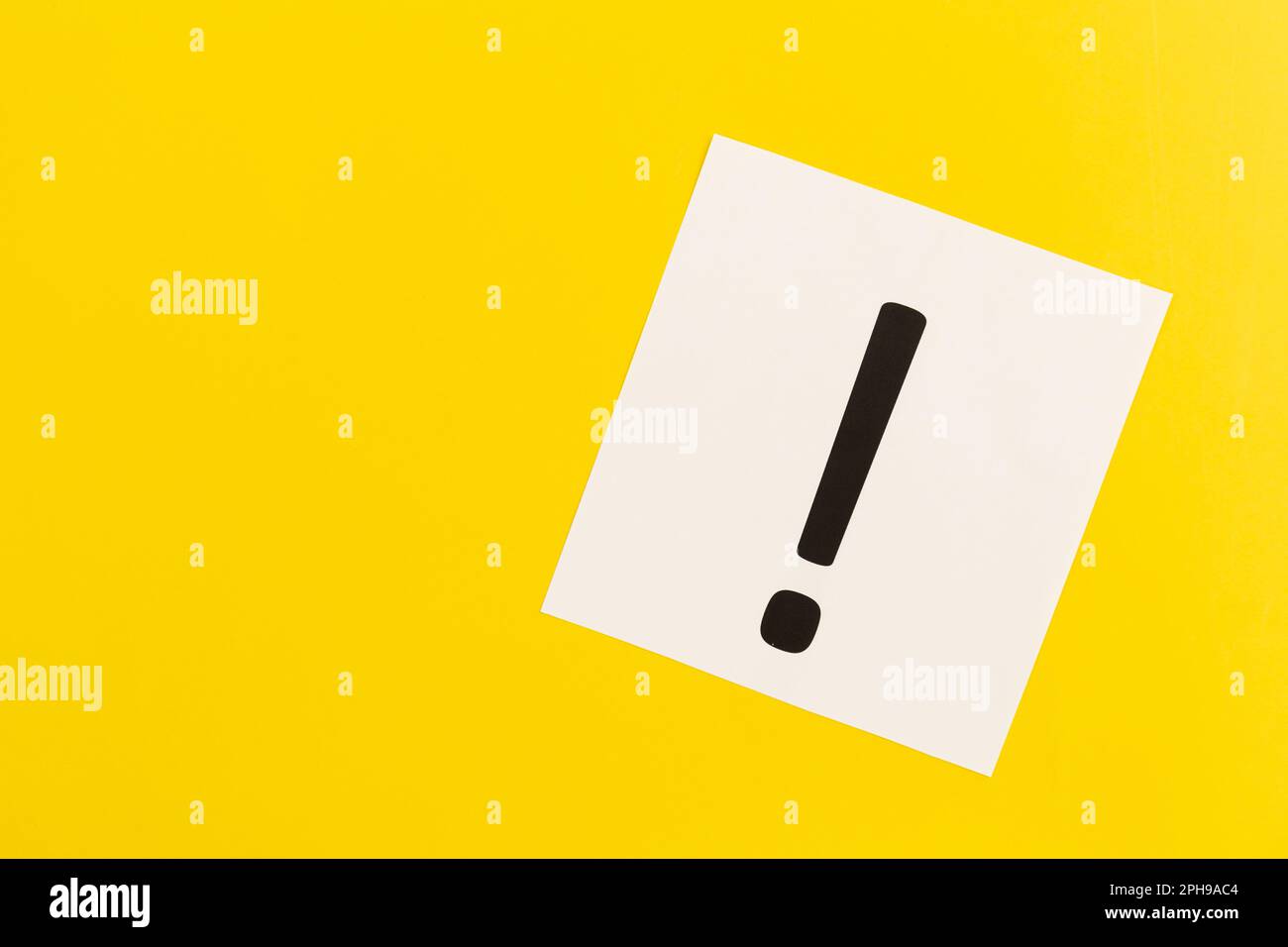 Exclamation mark on white paper on yellow background, flat lay Stock ...