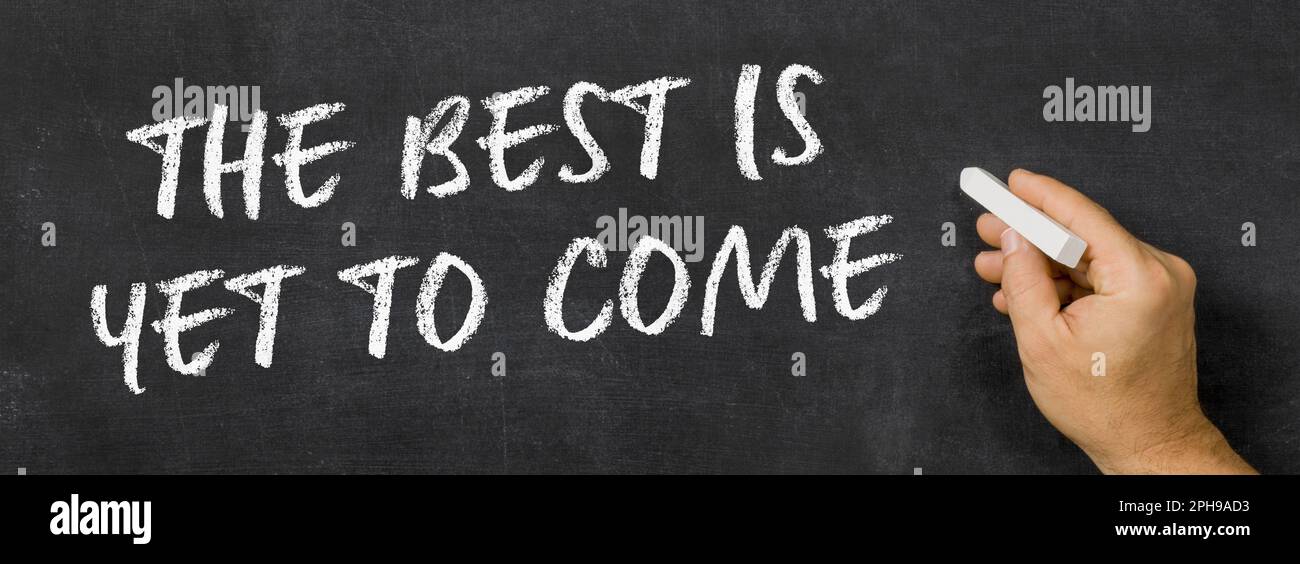 Text written on a blackboard - The best is yet to come Stock Photo - Alamy