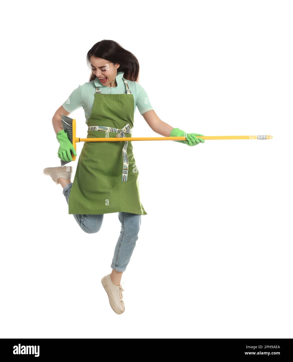 Beautiful young woman with broom jumping on white background Stock ...