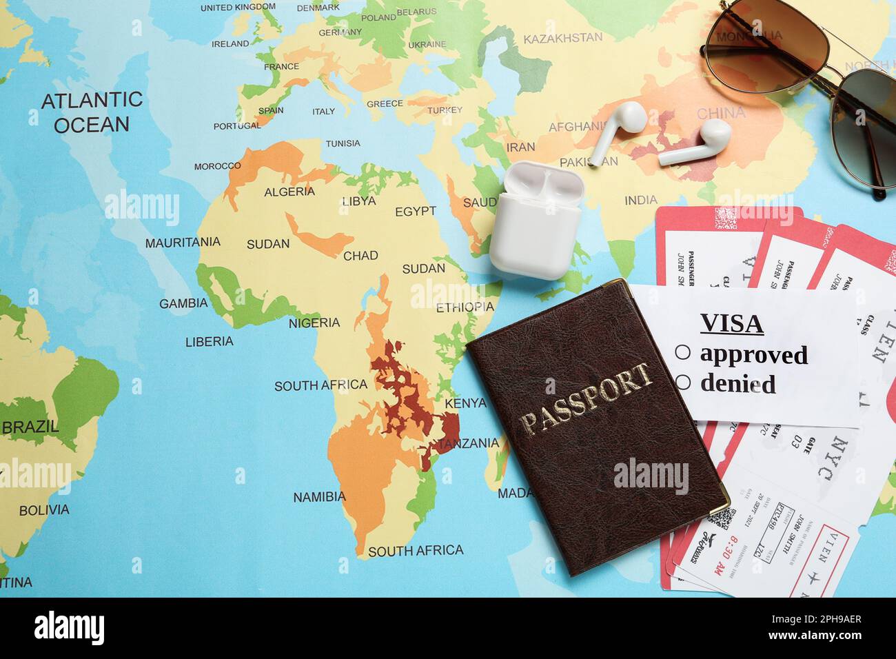 Flat lay composition with passport and tickets on world map. Space for ...