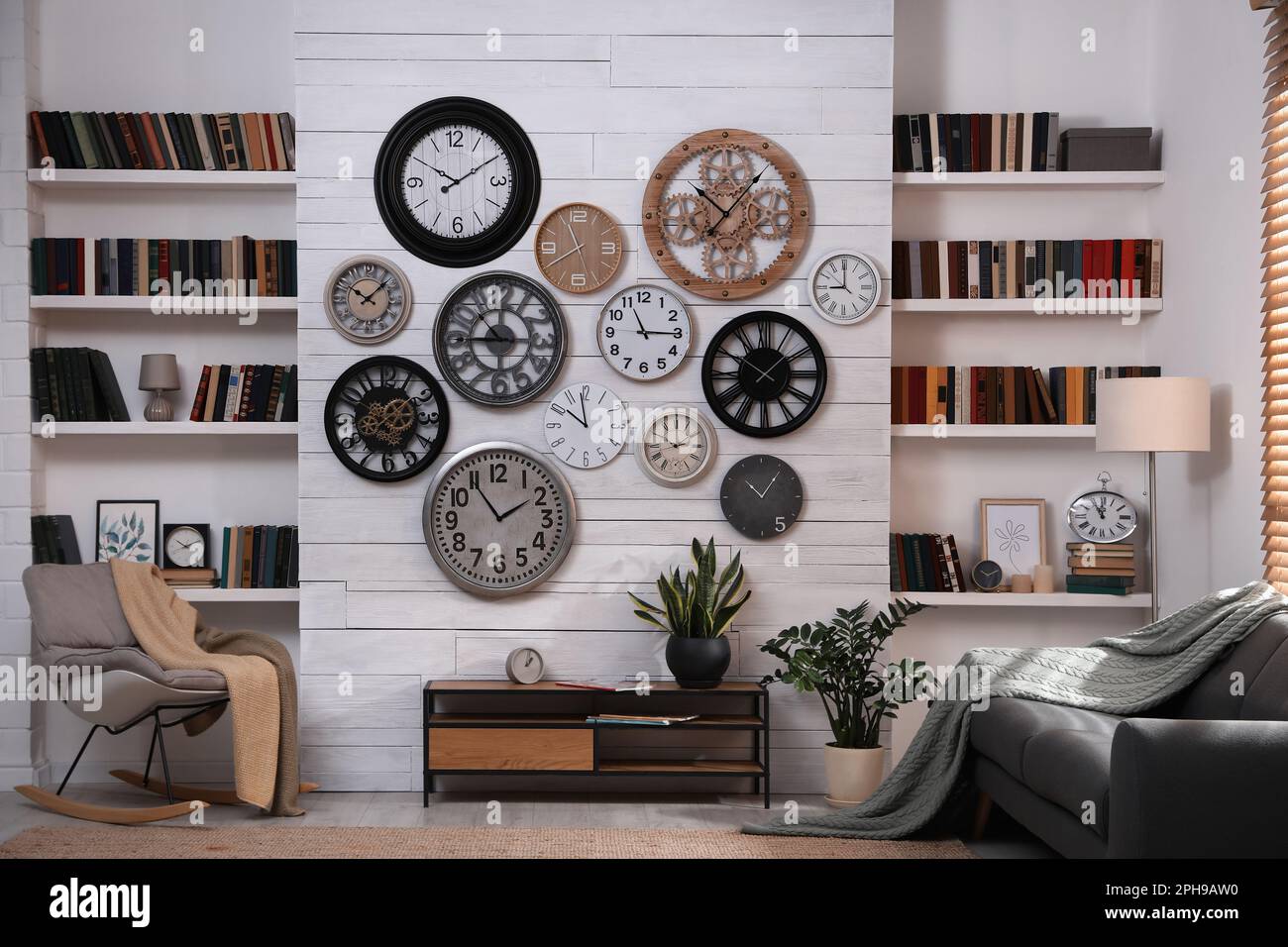 Stylish room interior with console table, comfortable furniture and ...