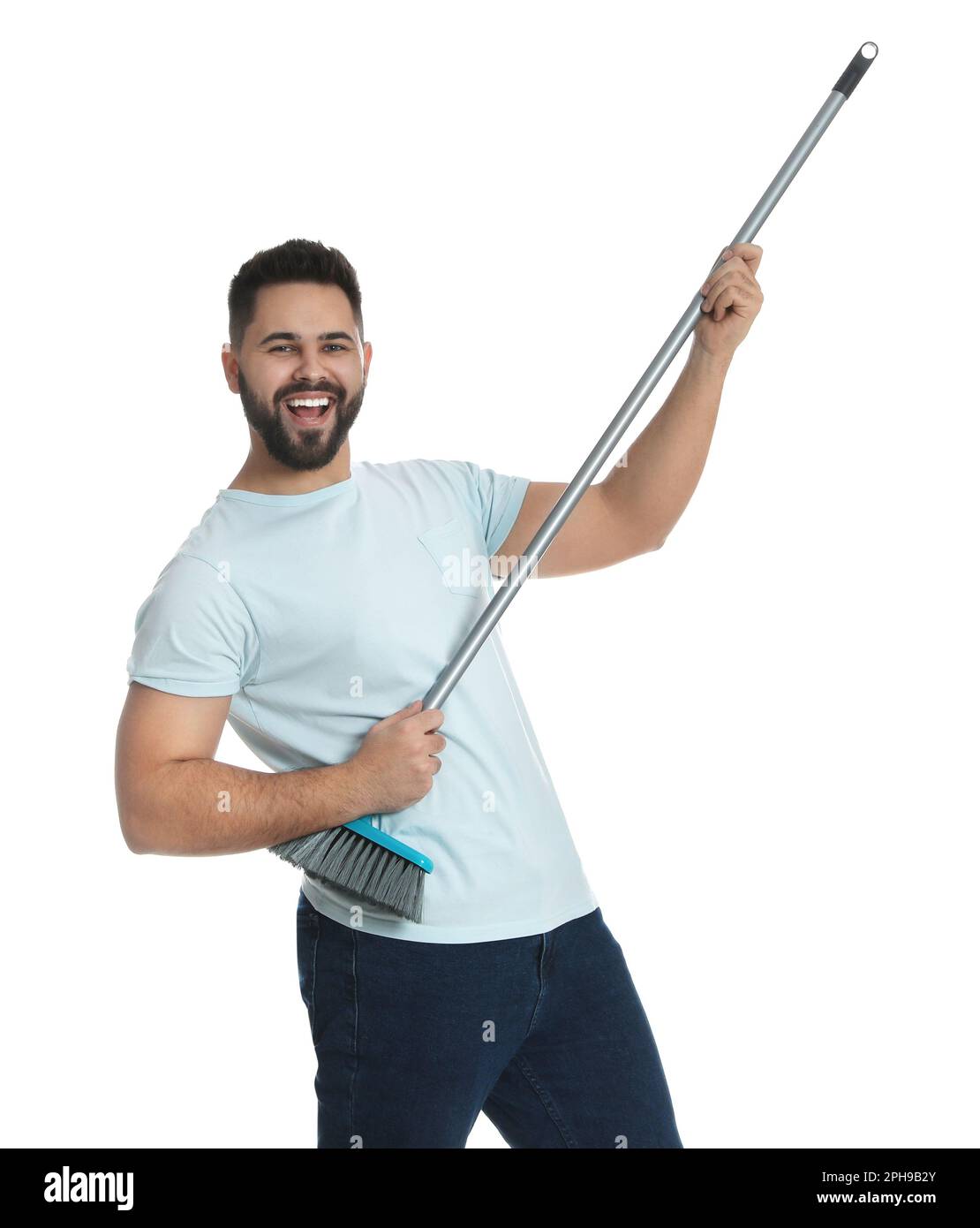 Young man with broom on white background Stock Photo - Alamy