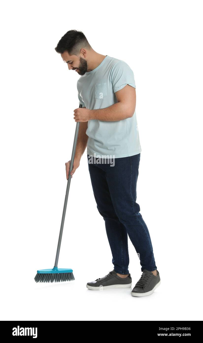 Young man with broom on white background Stock Photo - Alamy