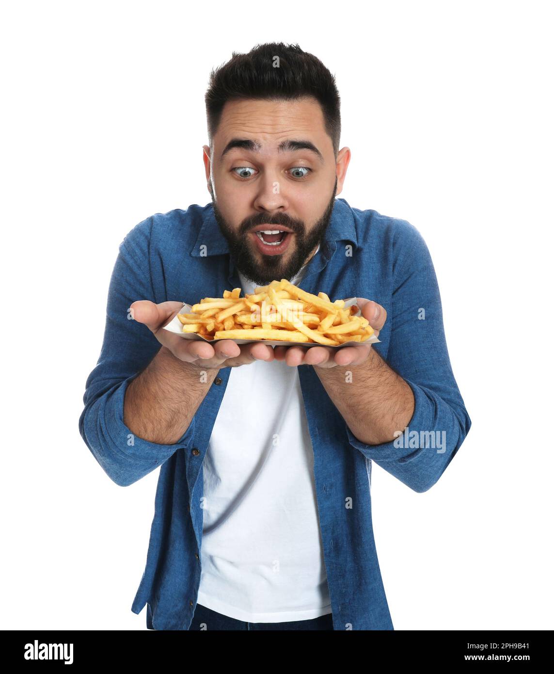 Hungry young man with French fries on white background Stock Photo - Alamy