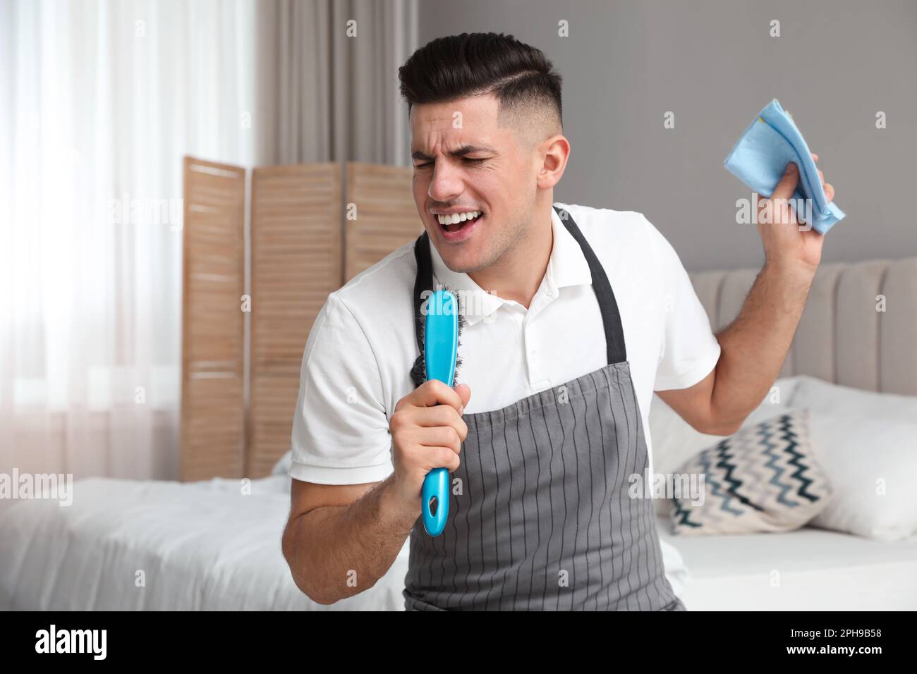 Singing into brush hi-res stock photography and images - Alamy