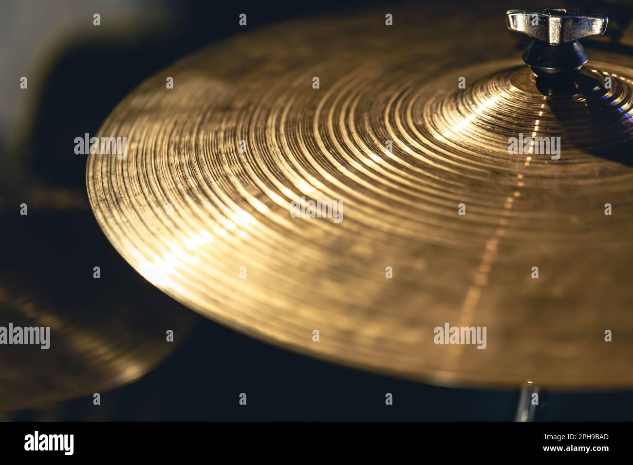 Drum cymbal close-up on a dark background Stock Photo - Alamy