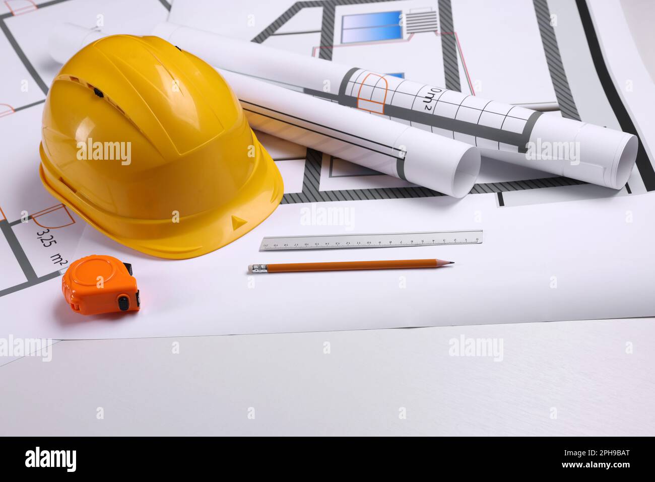 Construction drawings, safety hat, tape measure, pencil and ruler on ...
